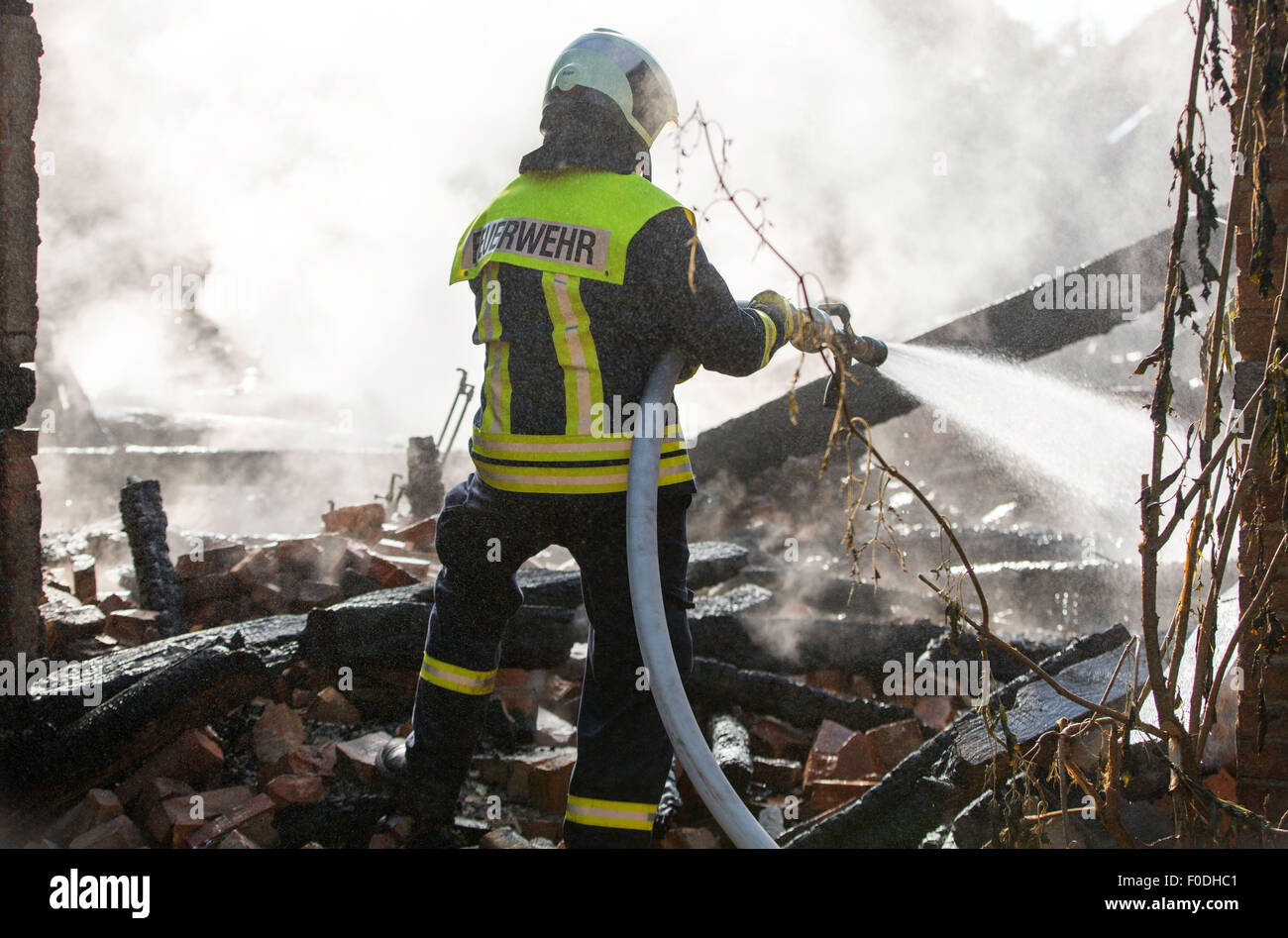 Jamel, Germany. 13th Aug, 2015. Firefighters extinguish the remains of ...