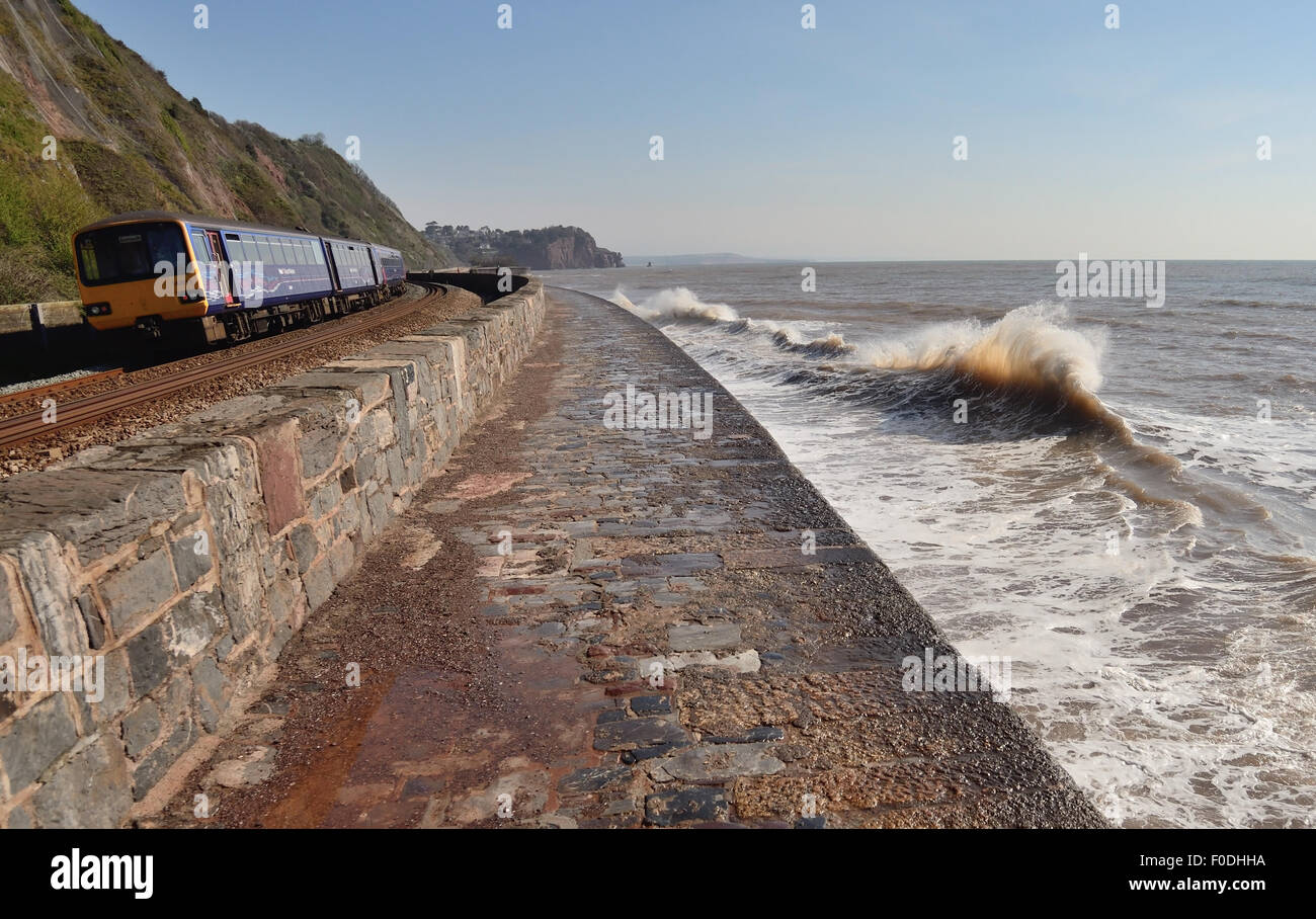 Local train alongside the sea wall at high tide Stock Photo - Alamy