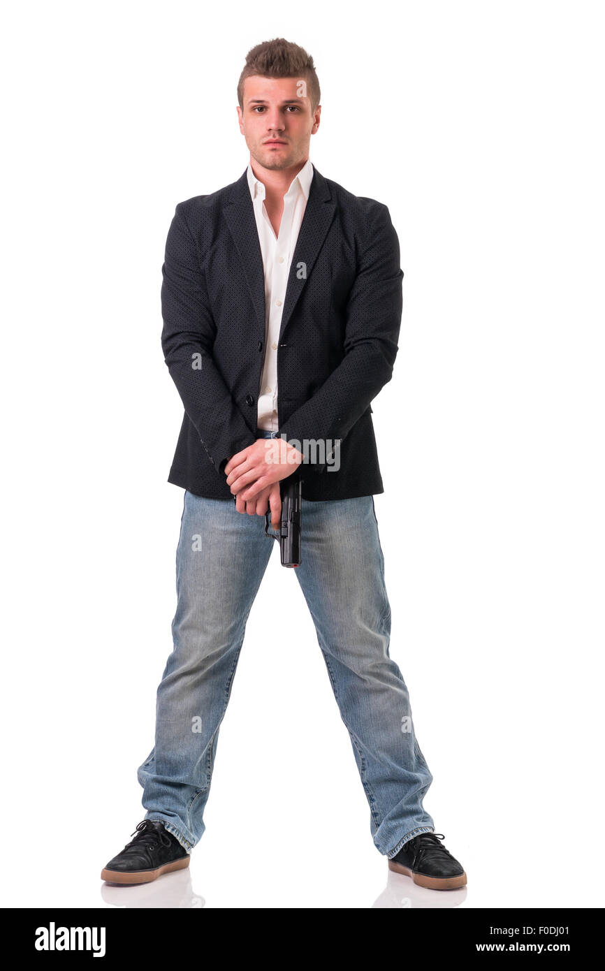 Elegant man with gun, dressed as a spy or secret agent, with earphones ...