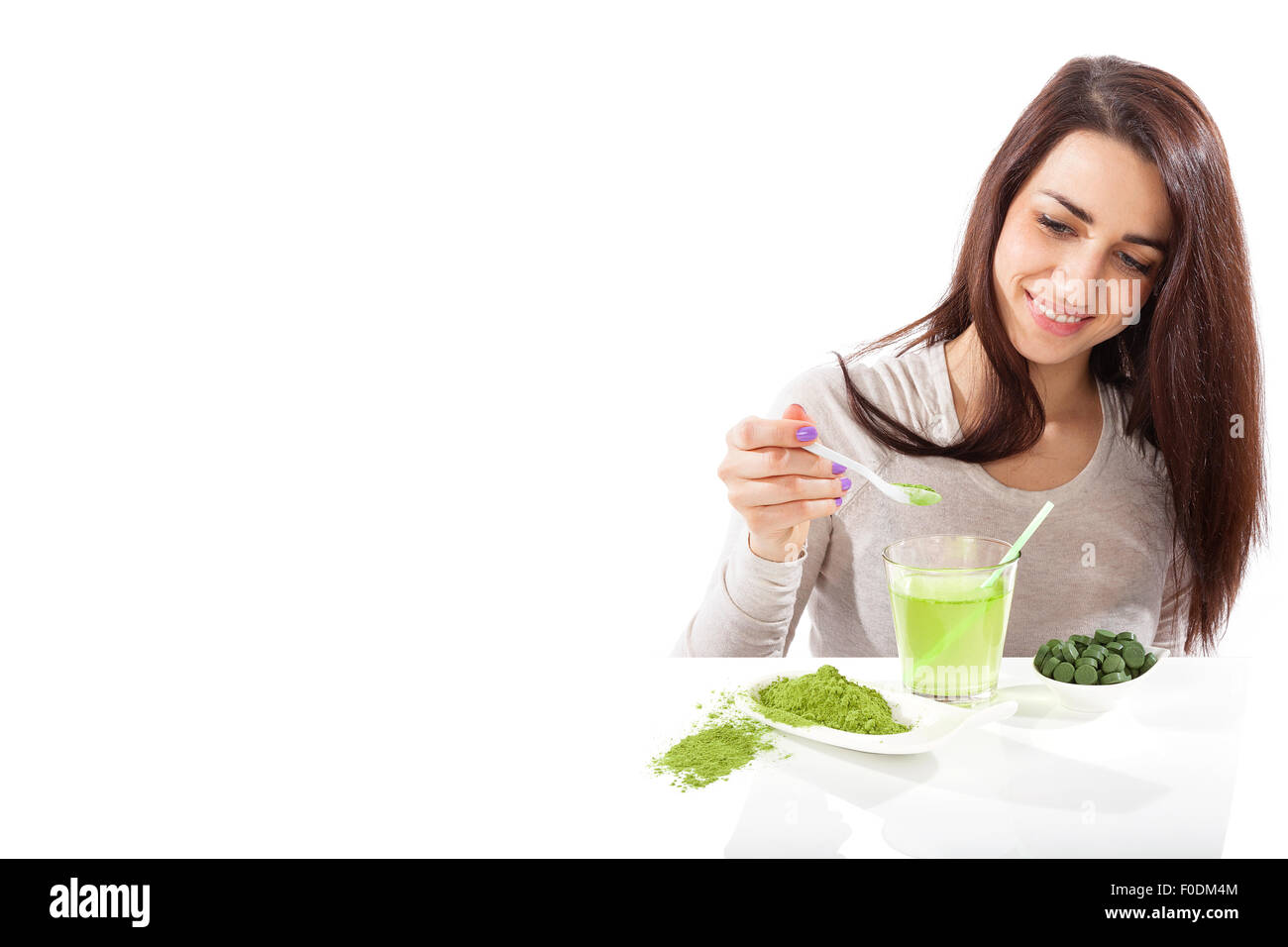 Detox. Beautiful girl with green drink in hand isolated on white ...