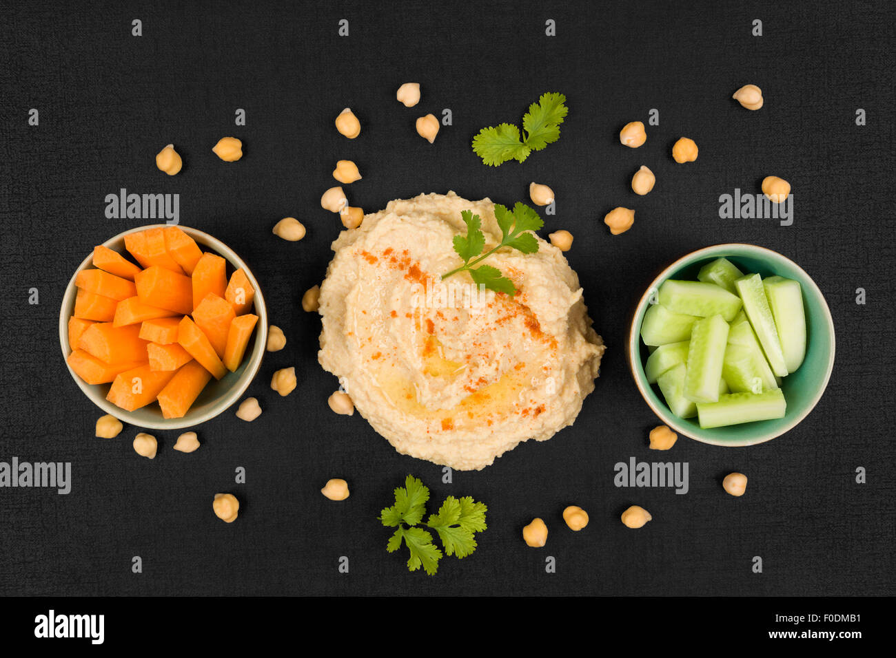 Delicious hummus background. Hummus, chickpeas, fresh carrot and ...