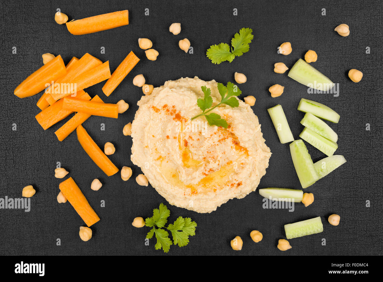 Delicious hummus background. Hummus, chickpeas, fresh carrot and ...