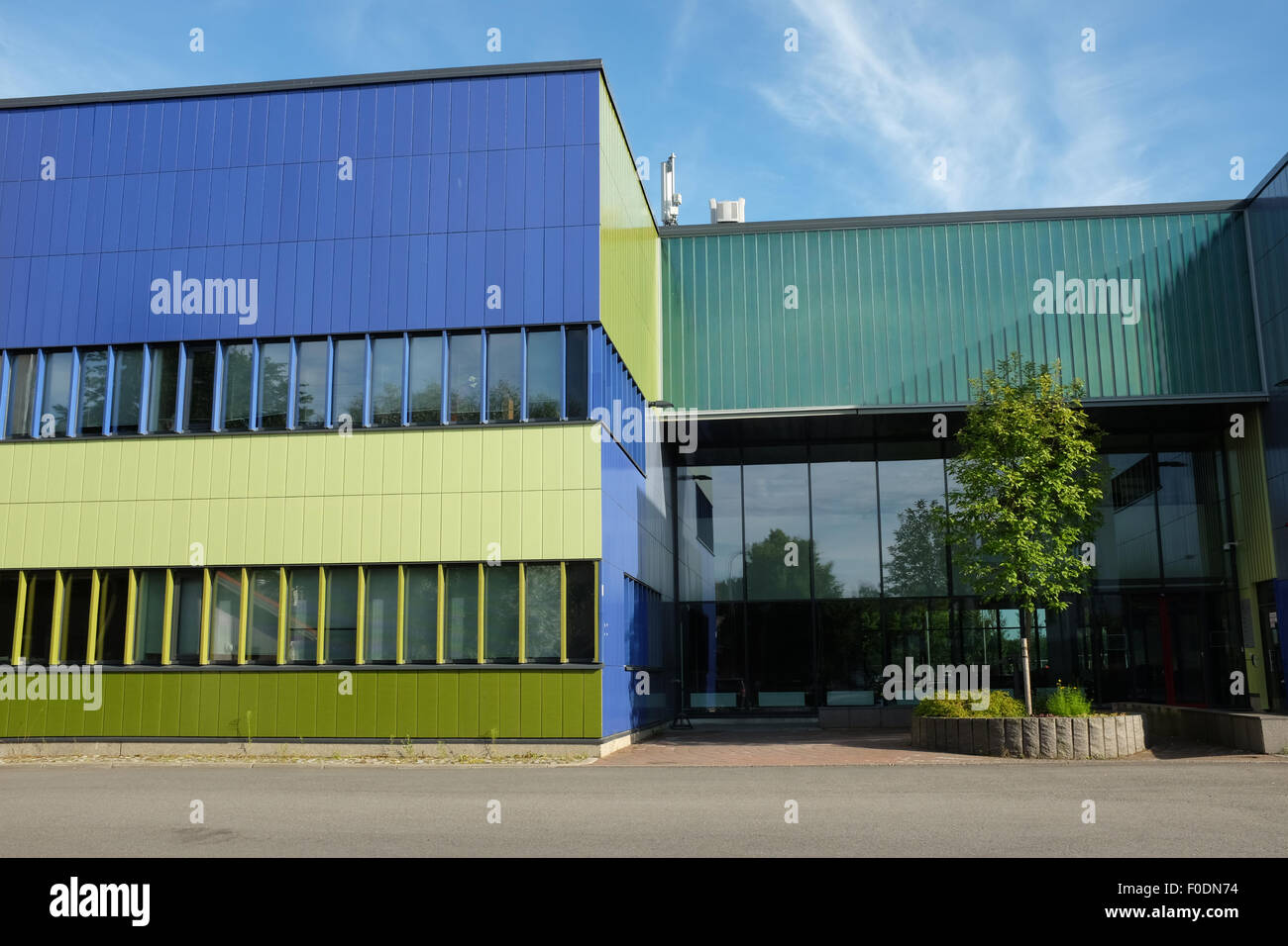 modern building with blue and green color wall, tree Stock Photo - Alamy