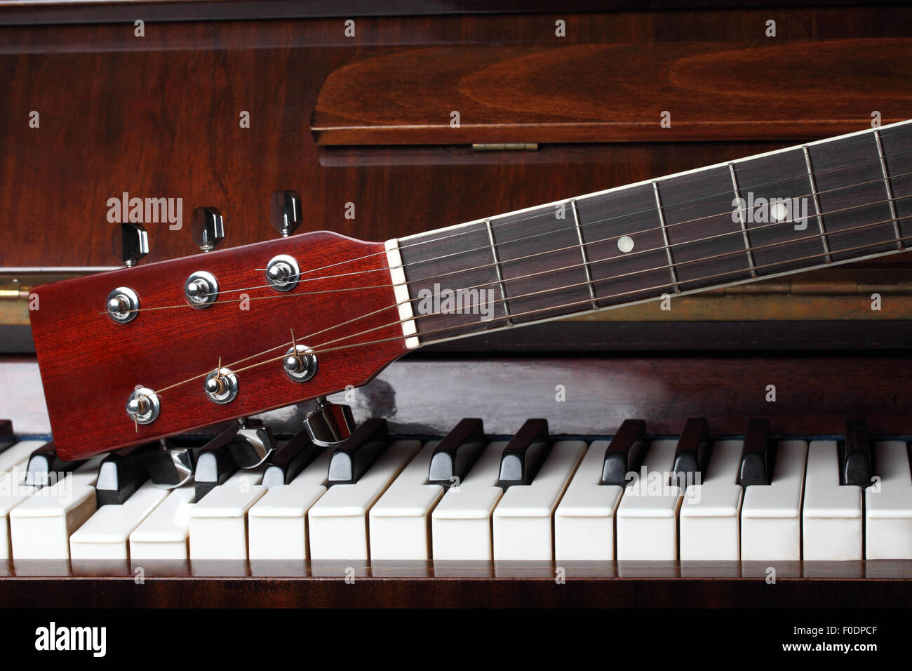 guitar neck on old piano keys Stock Photo - Alamy
