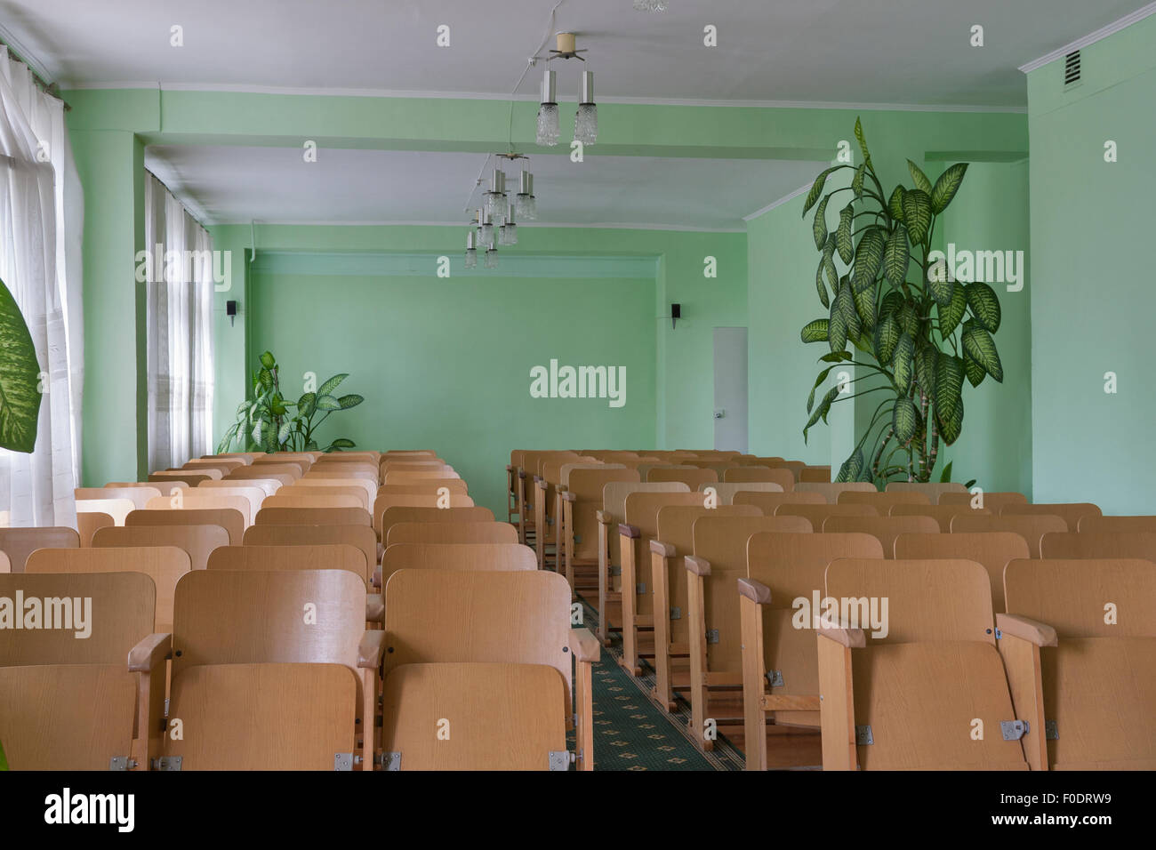 Vintage empty classroom with wooden chairs and indoor plants Stock ...