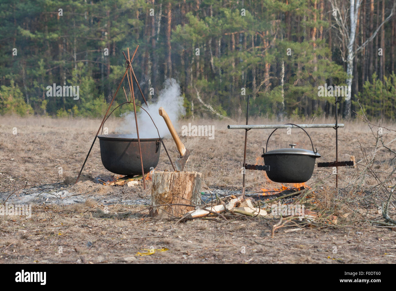 cooking food in two large cauldrons on the fire outdoor Stock Photo - Alamy
