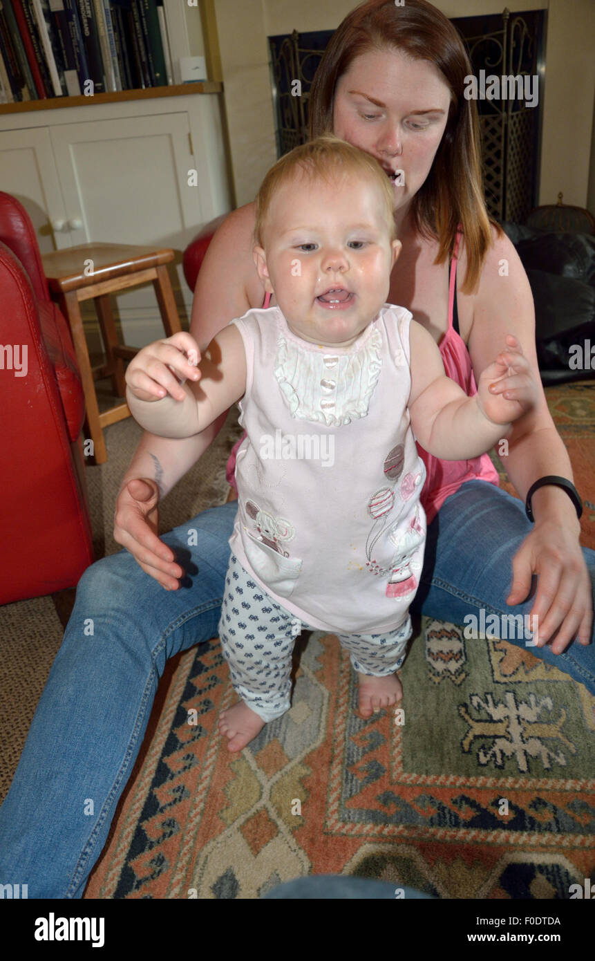 A ten month old baby taking her first walking steps Stock Photo - Alamy