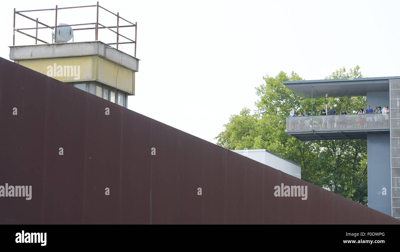 Berlin, Germany. 13th Aug, 2015. Tourists look at a watchtower from an ...