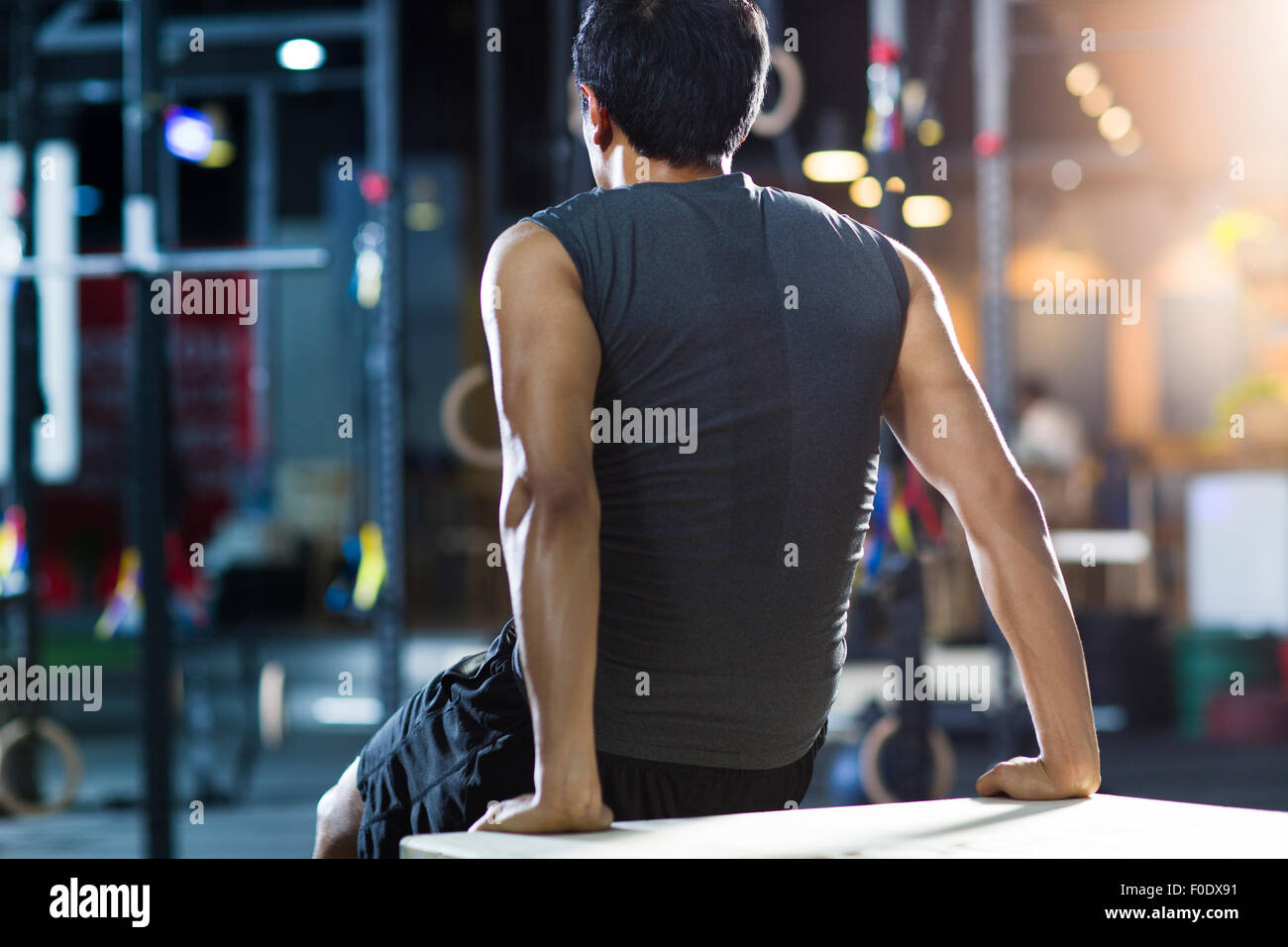 Young man sitting at gym Stock Photo - Alamy