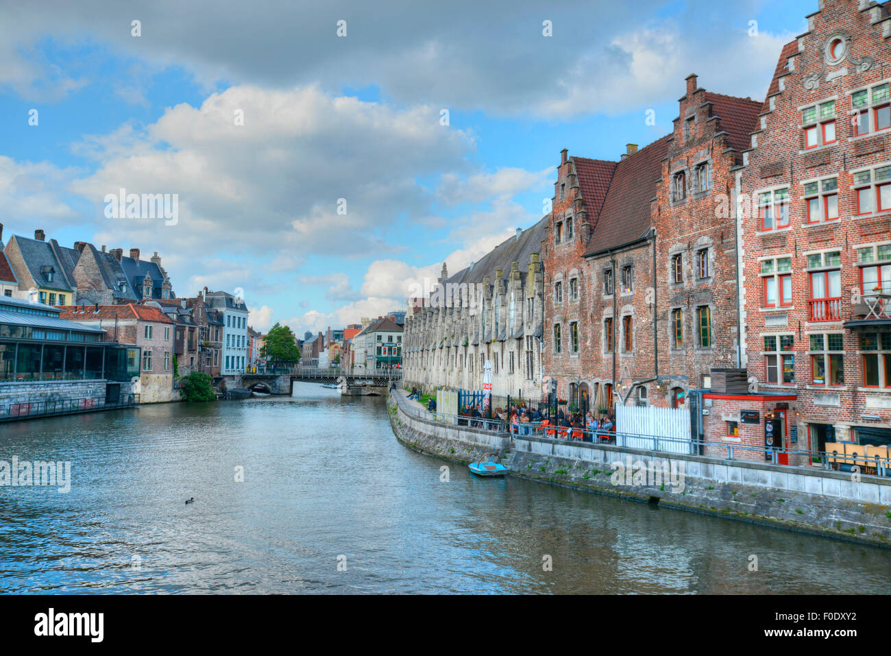 Beautiful canal at Ghent with river boats and medieval buildings Stock ...