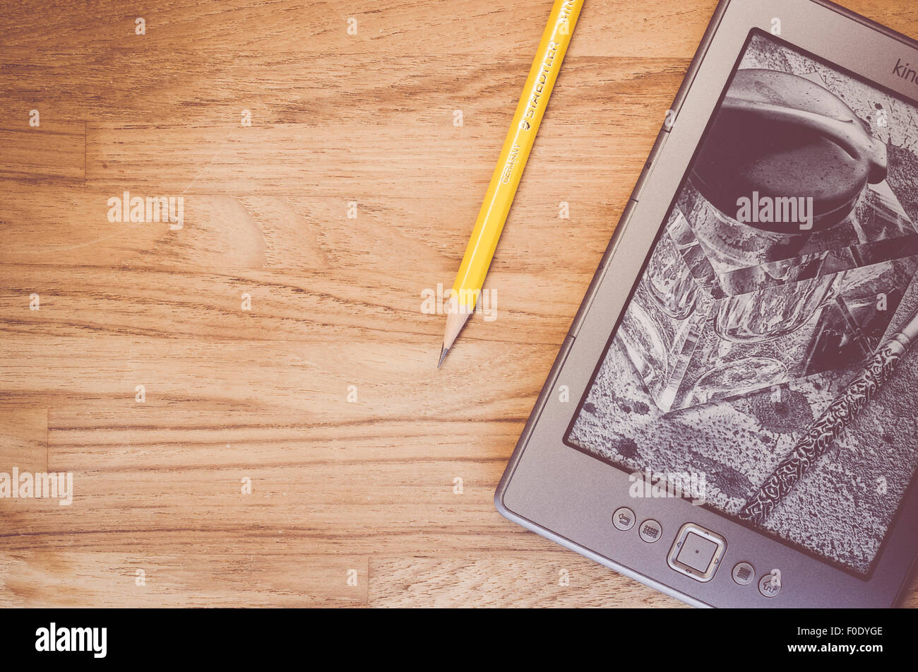 electronic reading device on a natural wood background - e-book reader ...
