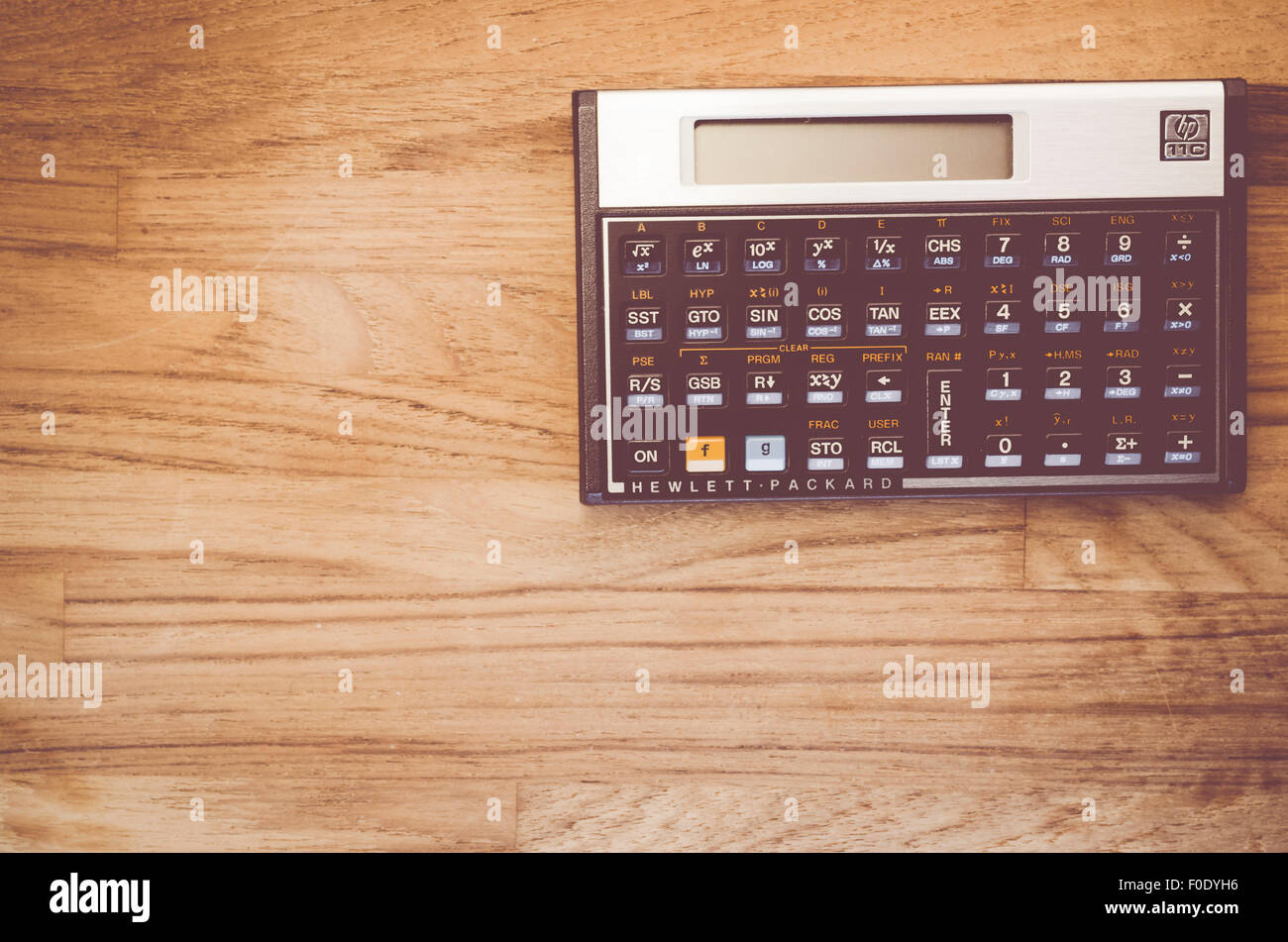 HP-11C programmable scientific calculator on a natural wood surface ...