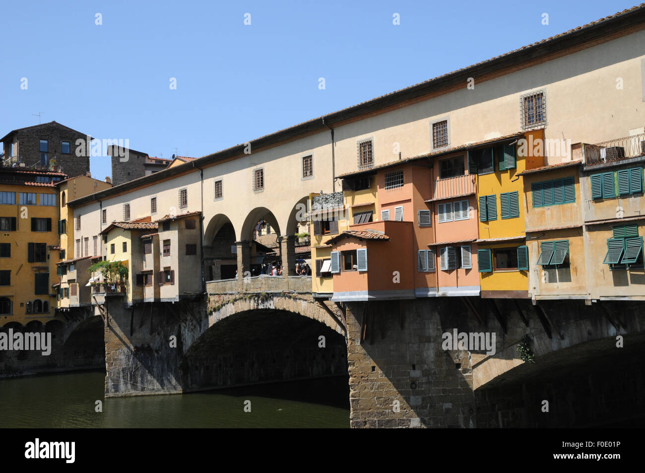 The Ponte Vecchio, or Old Bridge, the oldest bridge in Florence spans ...