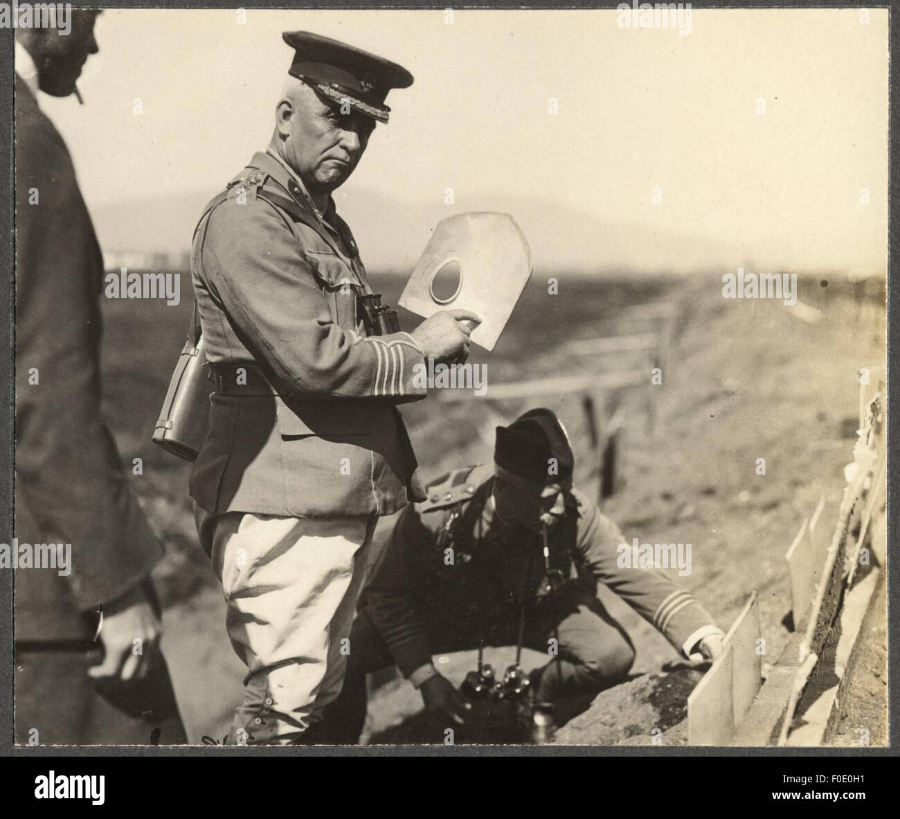 Colonel Hughes and Lieutenant Colonel Loomis examining bullet marks on ...