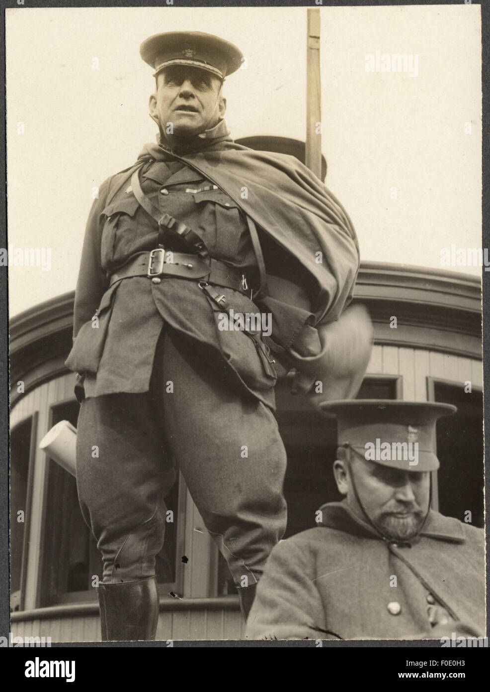 Colonel Sam Hughes, a military figure, is shown about to throw a bundle ...
