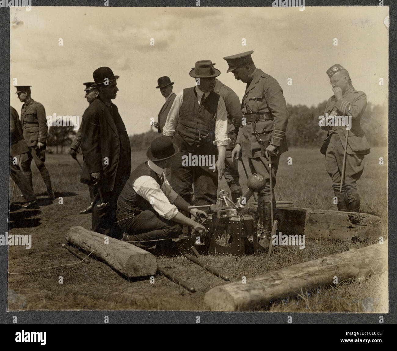 Civilian technicians are explaining the operation of a mortar during a ...