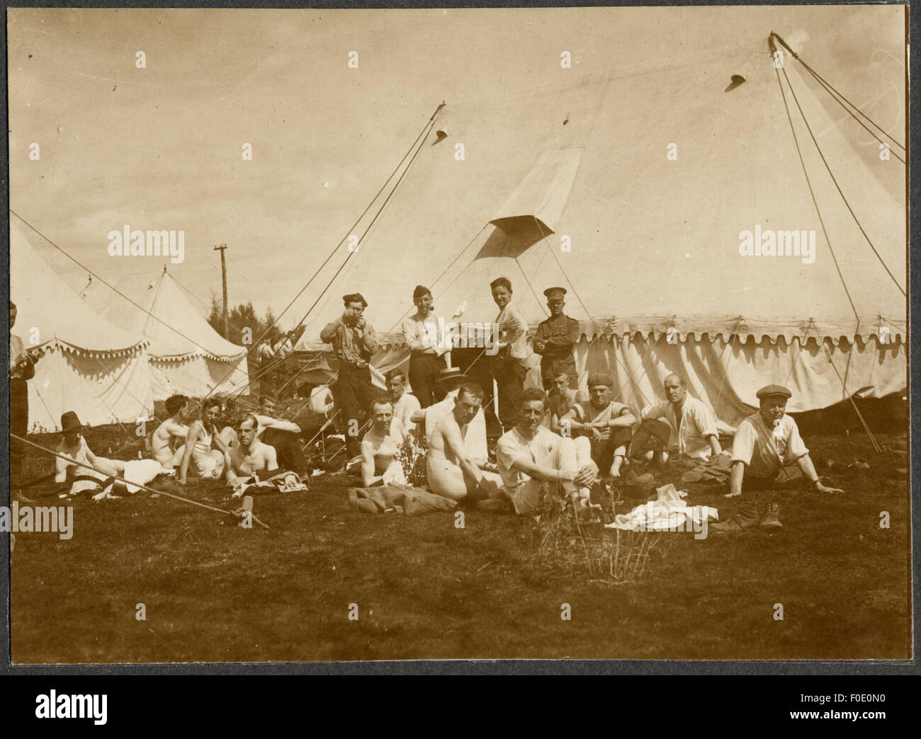 A historical image showing patients at a camp hospital, likely from a ...