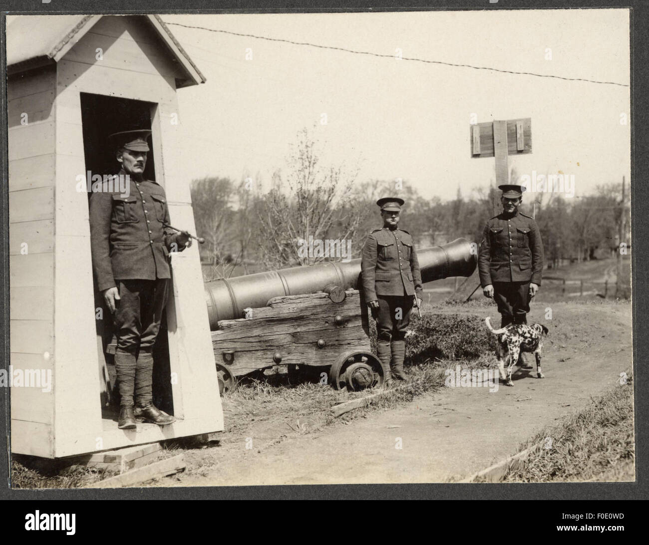 This image shows sentries standing guard next to an old cannon ...