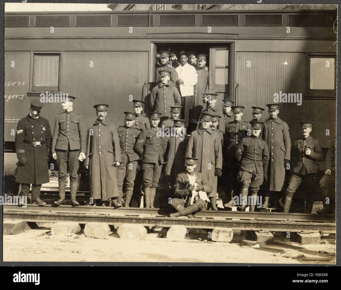 This historical photograph shows military troops and their train crew ...