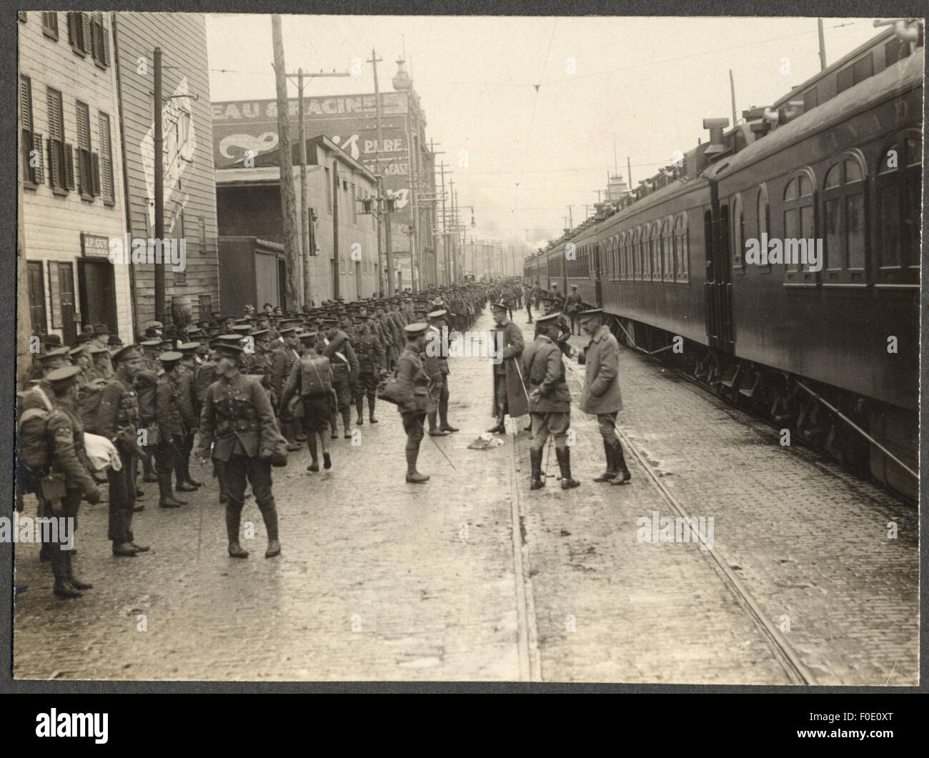 A historical photograph showing military troops boarding or traveling ...