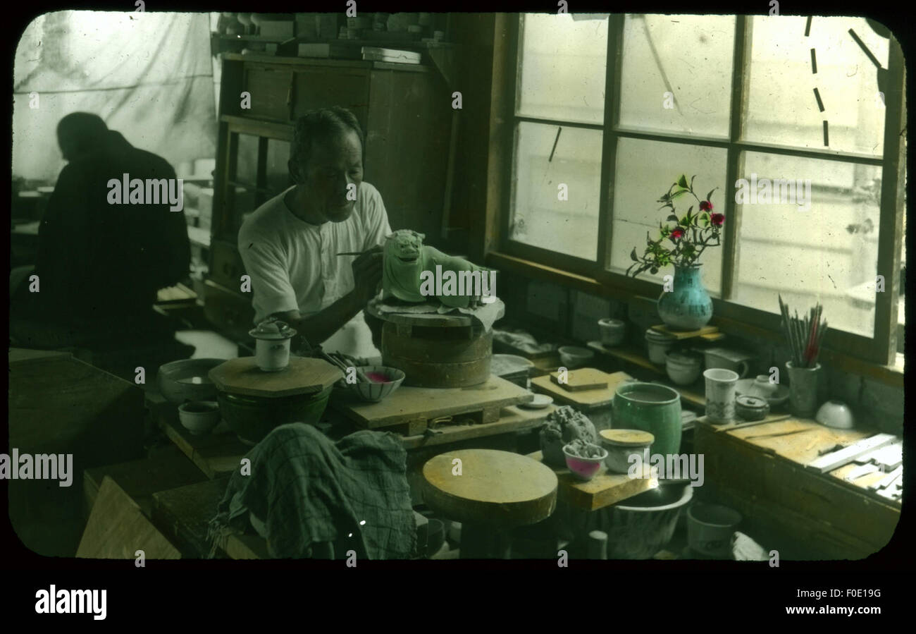 A potter is shown at work, carefully shaping a lion figure. The process ...