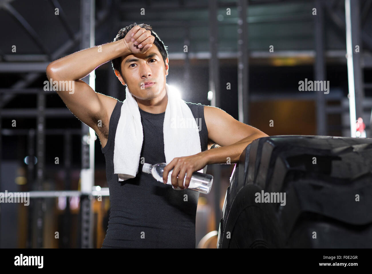 Young man resting at gym Stock Photo - Alamy