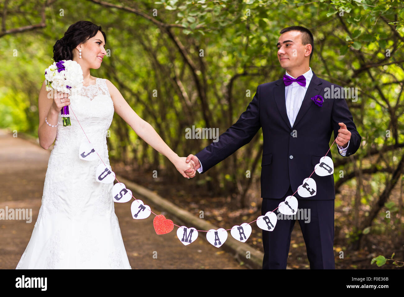 wedding couple with just married words Stock Photo - Alamy