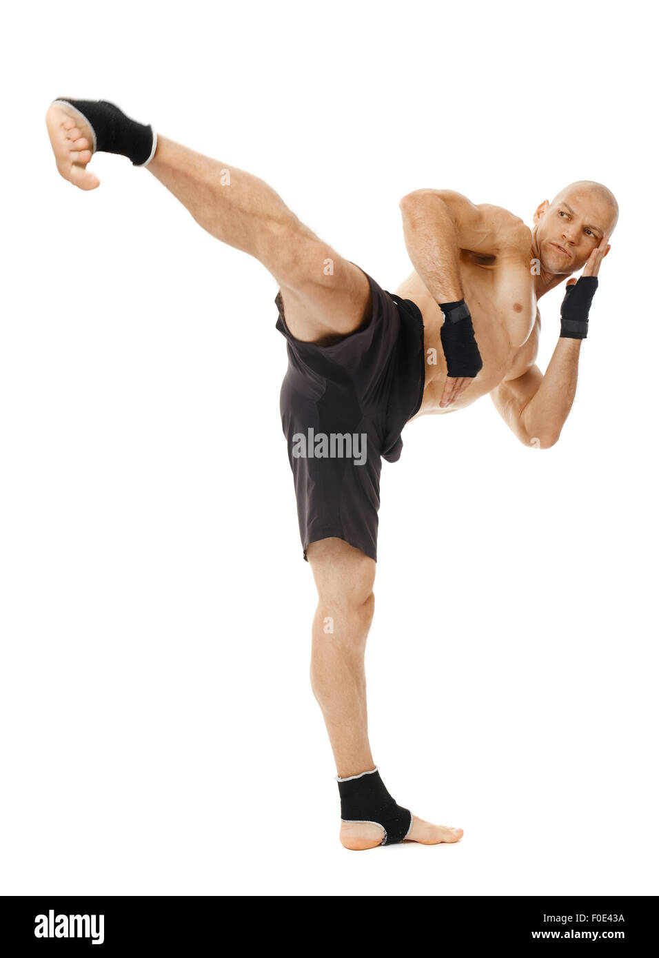 Kickbox or muay thai fighter executing a powerful kick isolated on ...