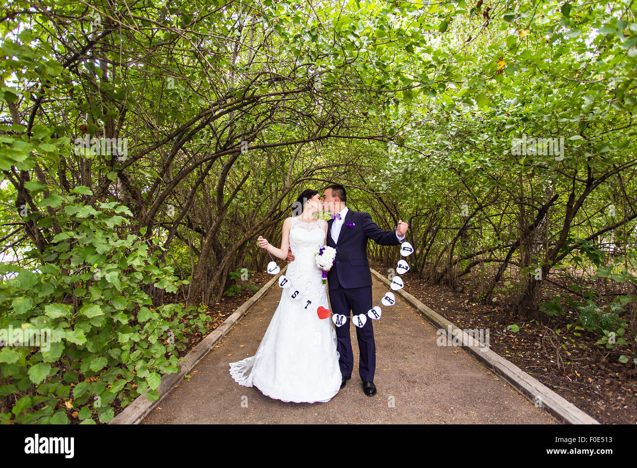 wedding couple with just married words Stock Photo - Alamy