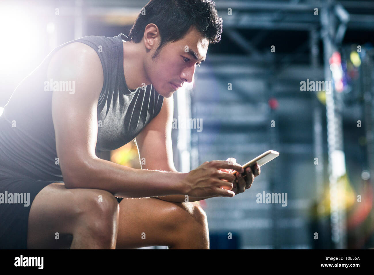 Modern gym man sitting down hi-res stock photography and images - Alamy
