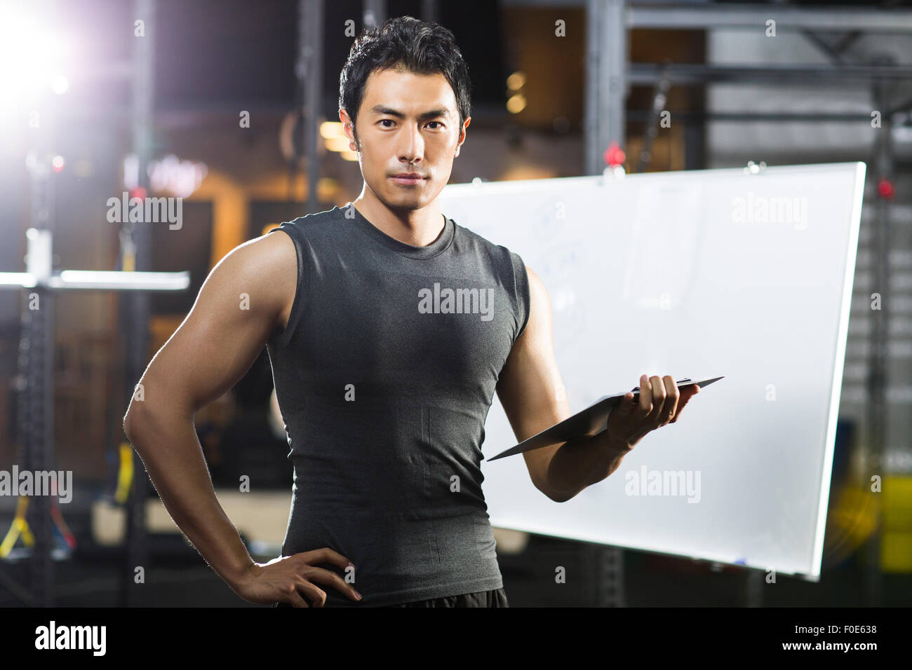 Coach making exercise plan in gym Stock Photo - Alamy