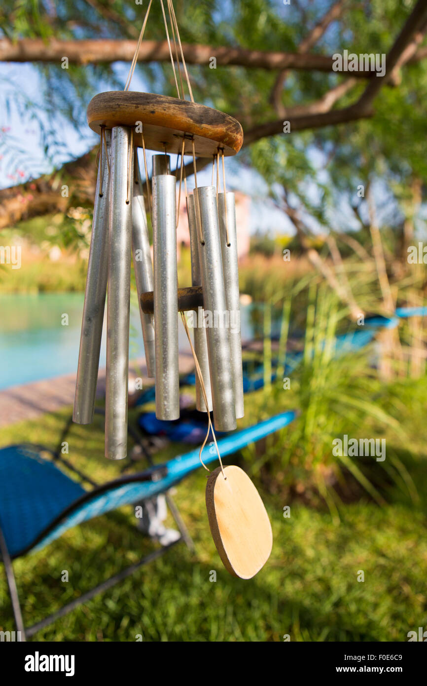 A Wind chime isolated against a natural background. The garden, chair ...