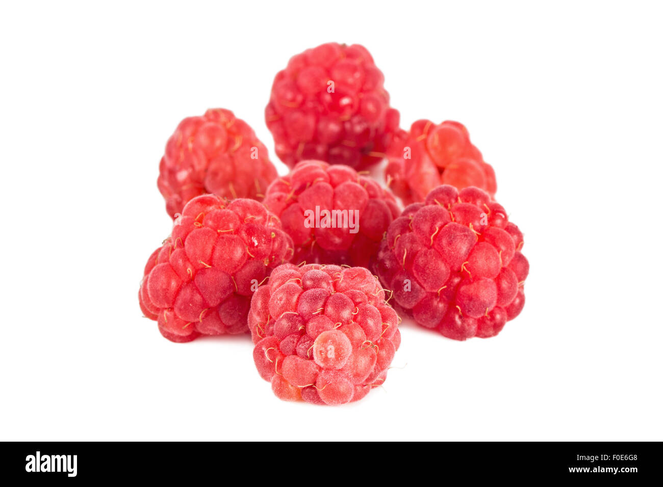 Close-up of a small group of ripe red raspberries, isolated on white ...