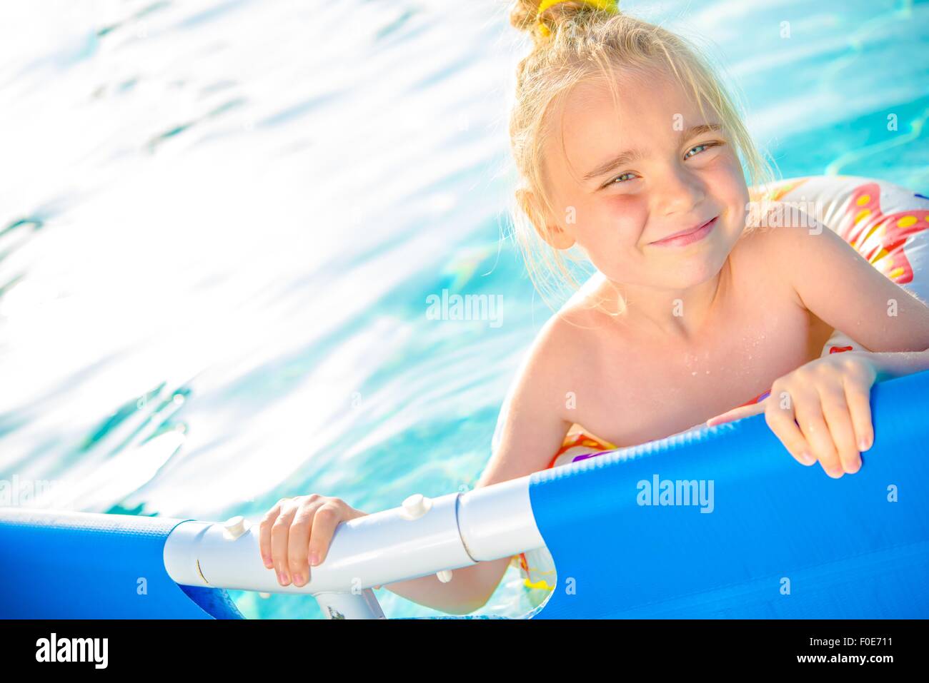 Little Girl Enjoying Backyard Swimming Pool. Summertime Water Fun Stock ...