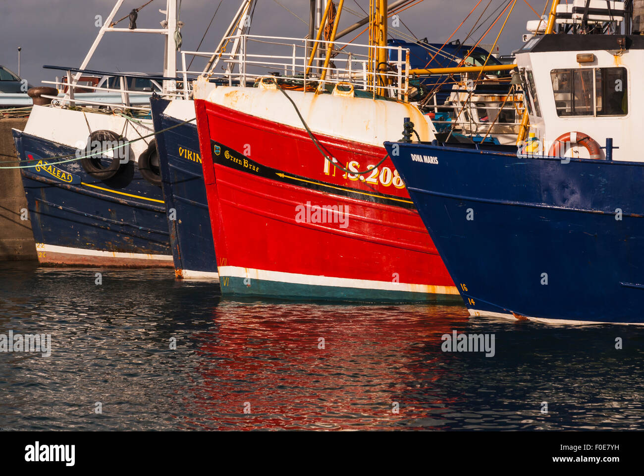 The bows of four boats tied up alongside at Mallaig, lochaber, Scotland ...