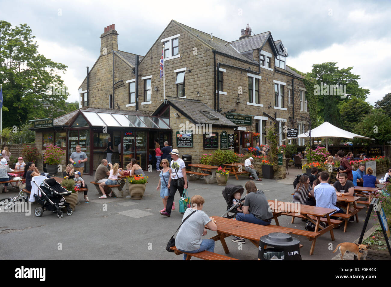 People enjoy the summer weather at the Ilkley Riverside Hotel Stock ...