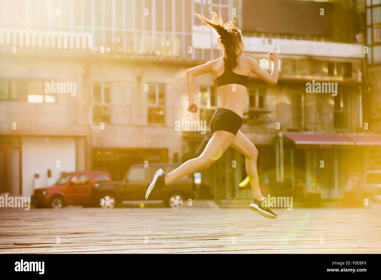 Young jogger running outdoors Stock Photo - Alamy