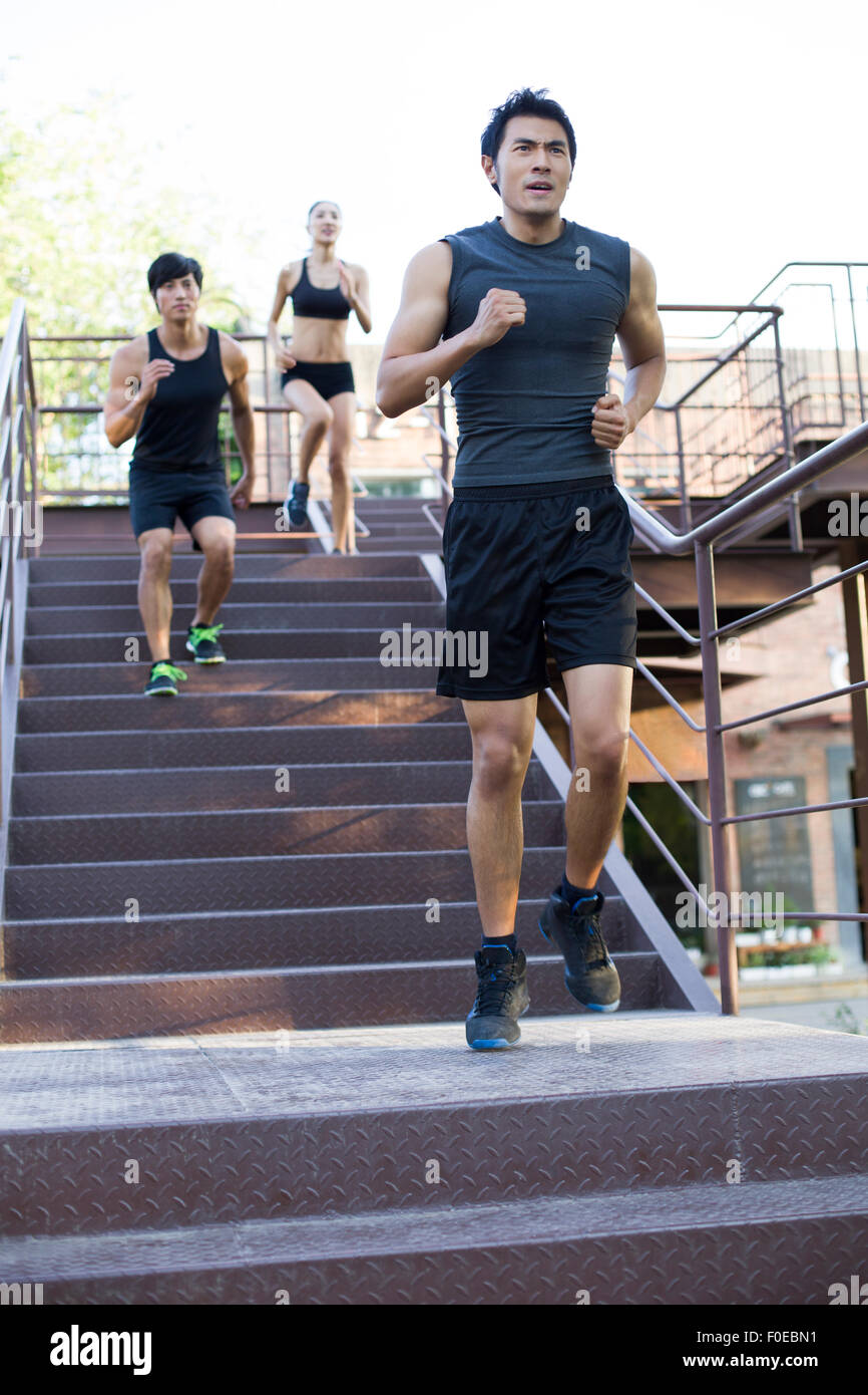 Young joggers running down steps outdoors Stock Photo - Alamy