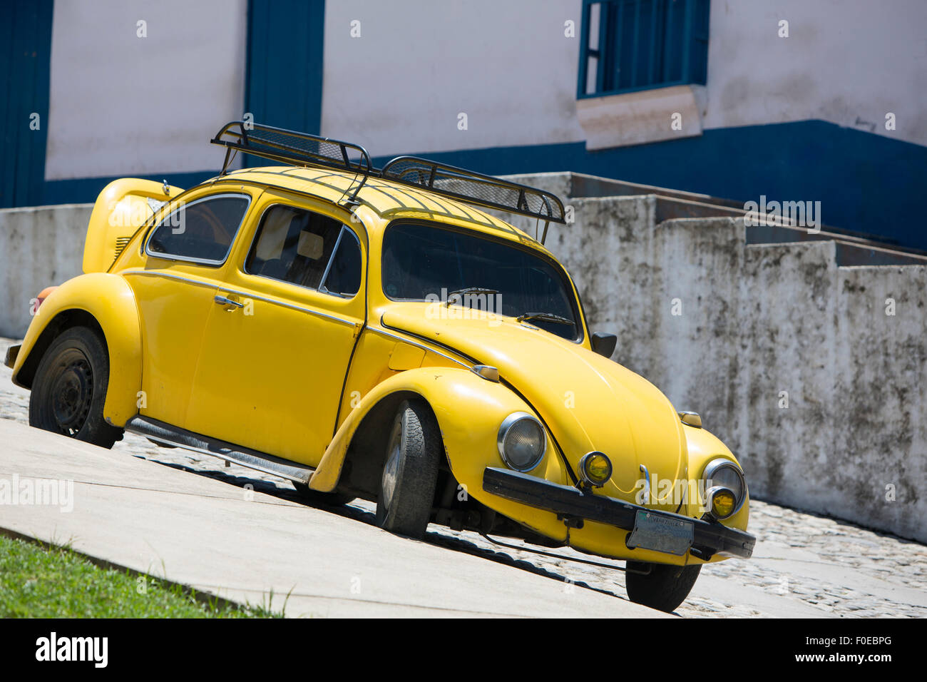 Yellow timer Volkswagen Beetle parked in the street of a colonial city ...