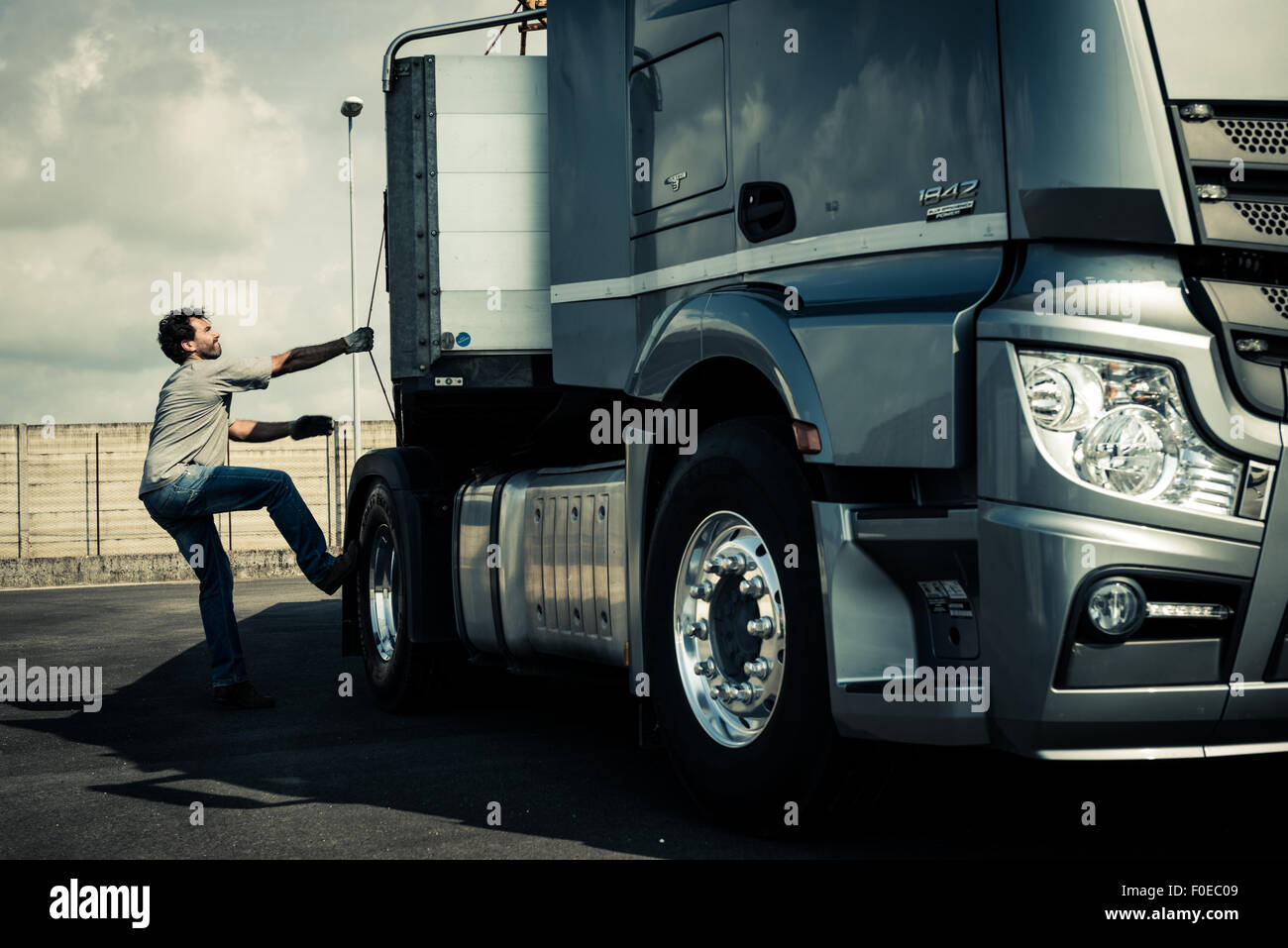 Truck driver with tractor trailer truck Stock Photo - Alamy
