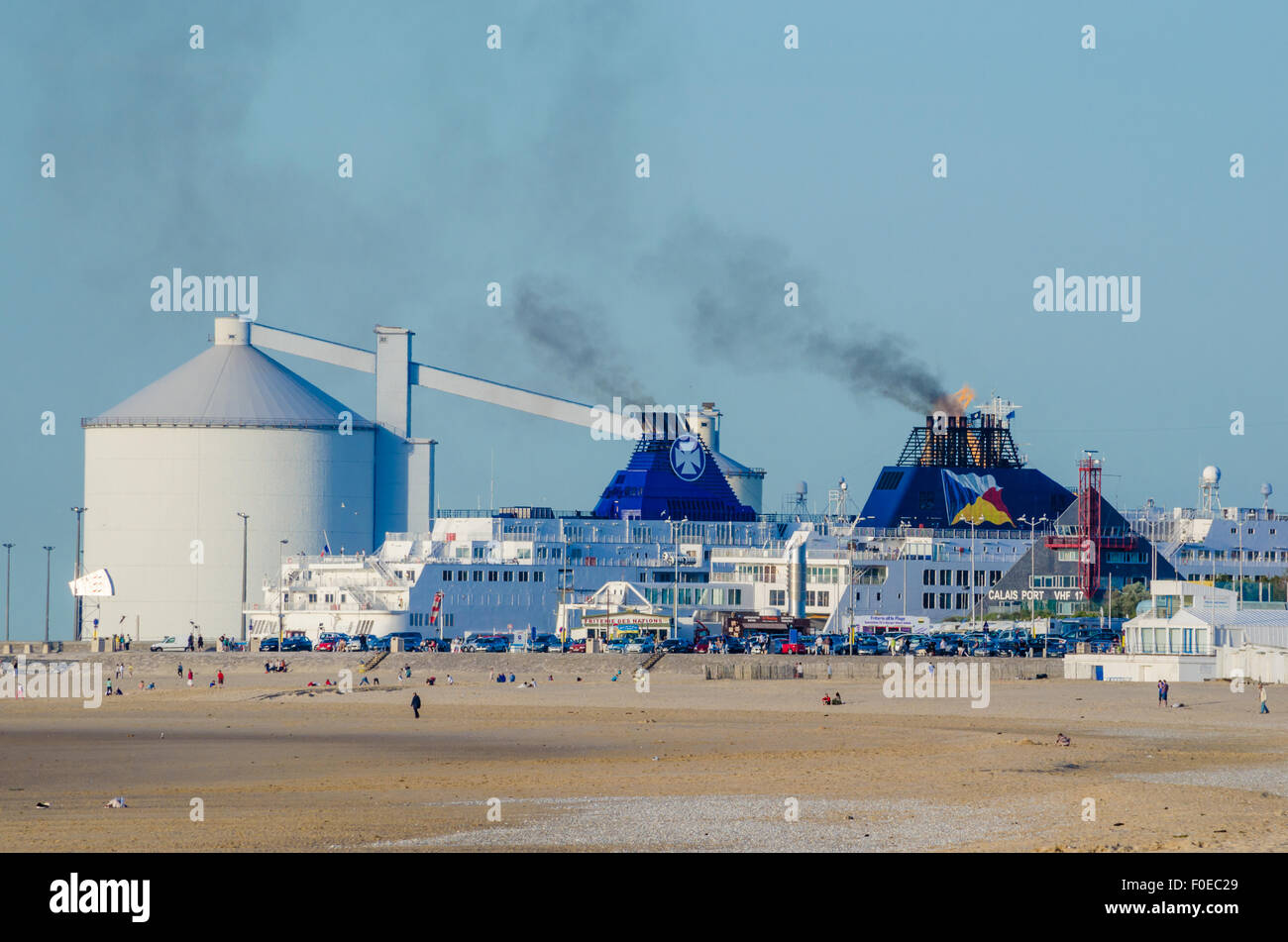 Calais harbour with channel ferries with the beach in the foreground ...