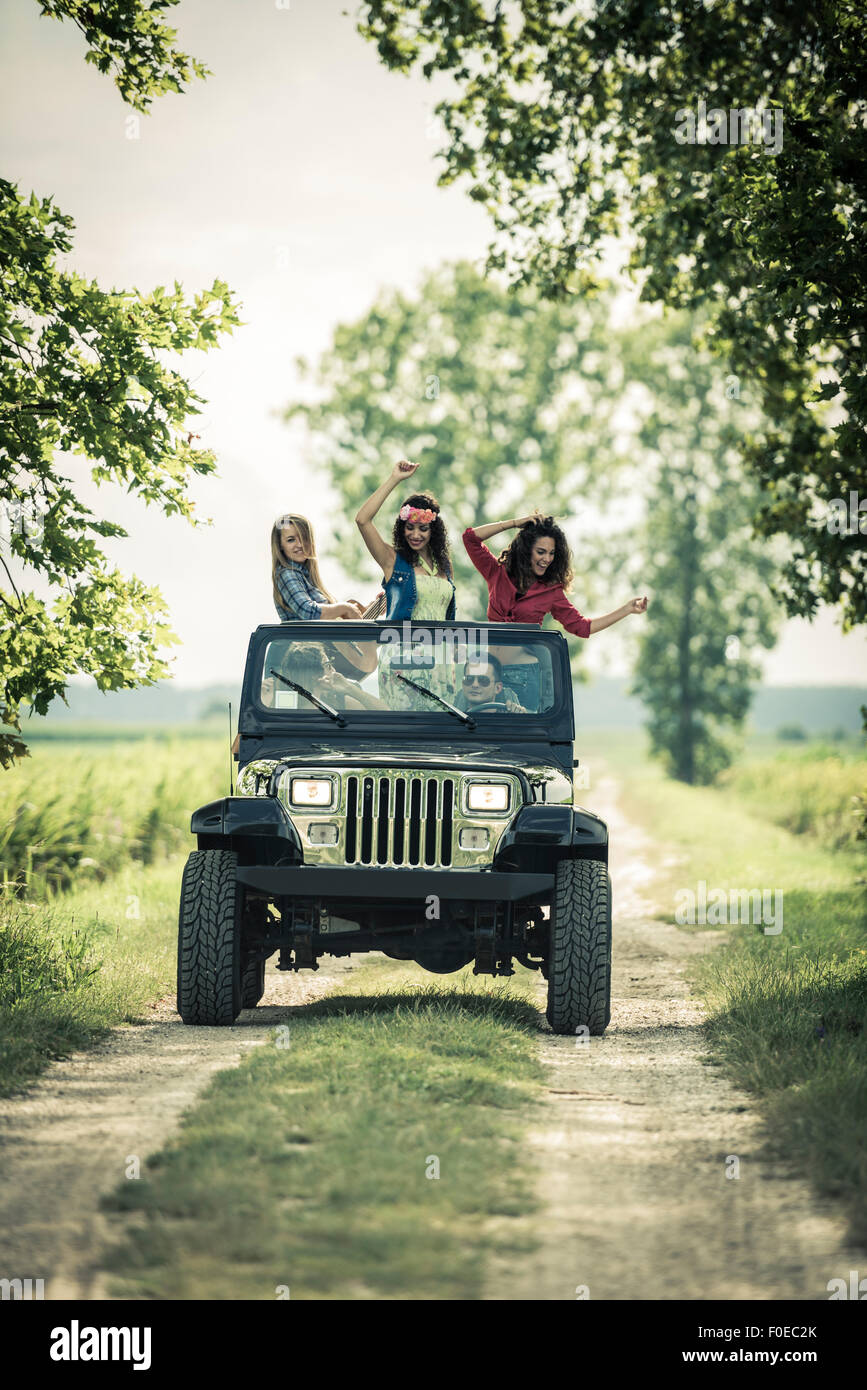 Excited women having fun on a jeep Stock Photo - Alamy