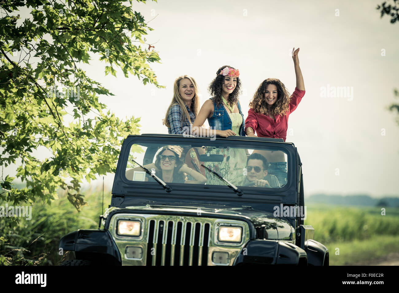 Excited women having fun on a jeep Stock Photo - Alamy