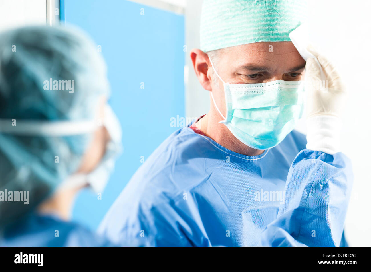 Nurse wiping surgeon s brow Stock Photo - Alamy