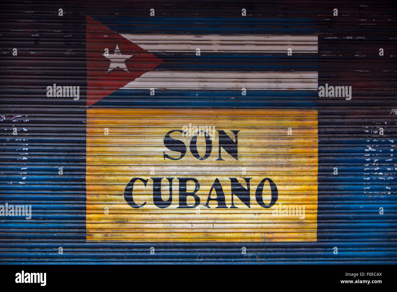 Graffiti on a door representing the flag of cuba and the words cuban ...