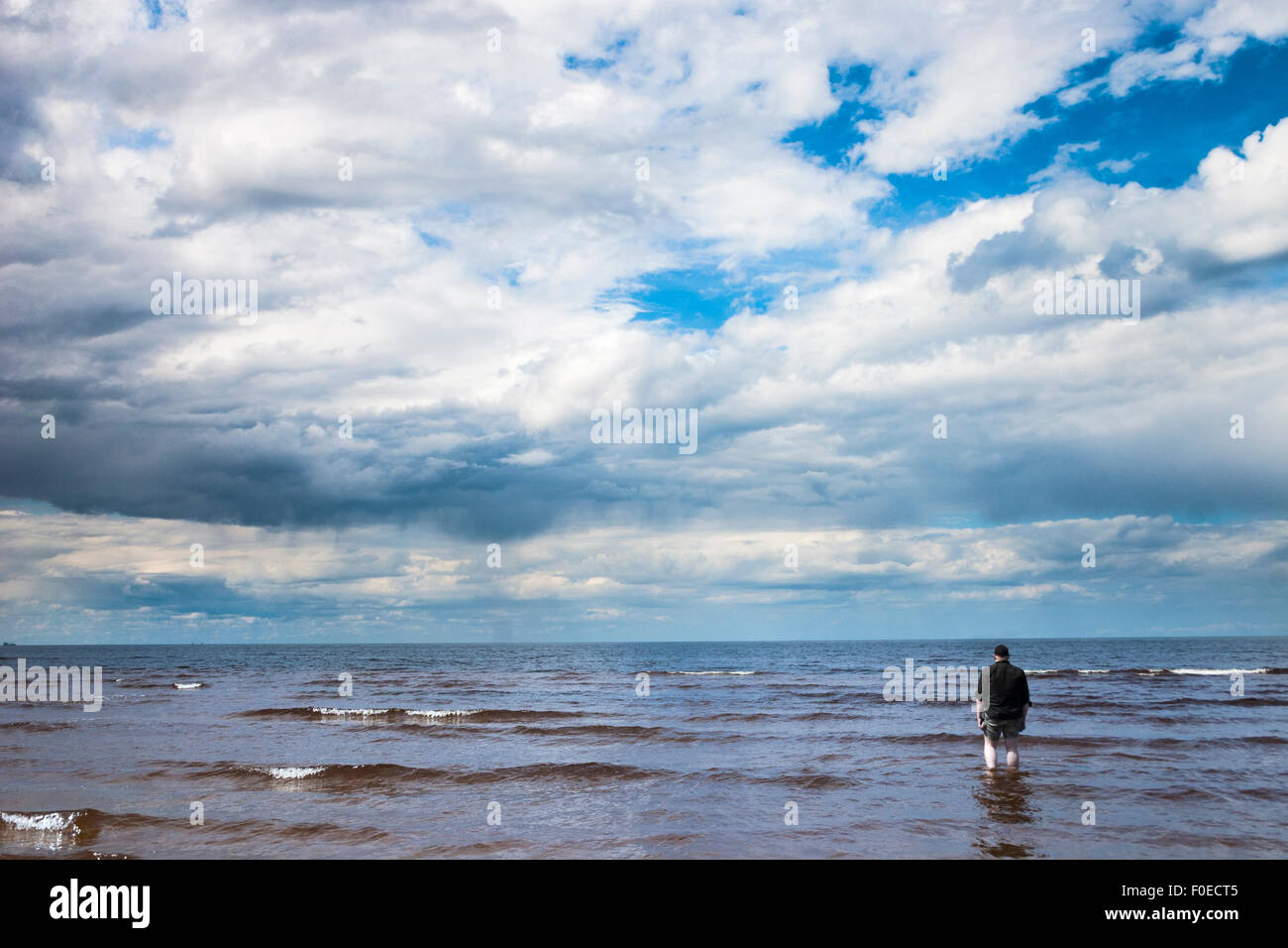 Man wading in the sea Stock Photo - Alamy