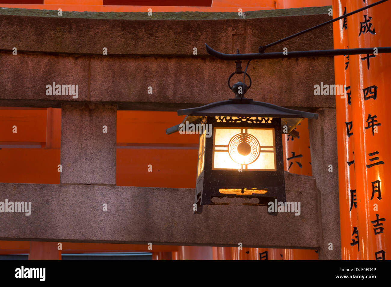 Lantern and vermilion torii along pathway in Fushimi Inari Shinto ...