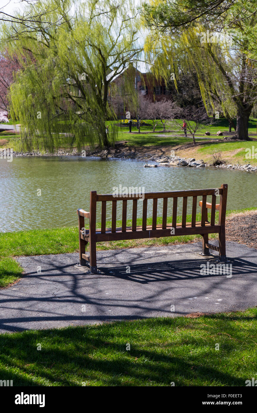 A park bench in a serene scene at a suburban park known as Greenfield ...