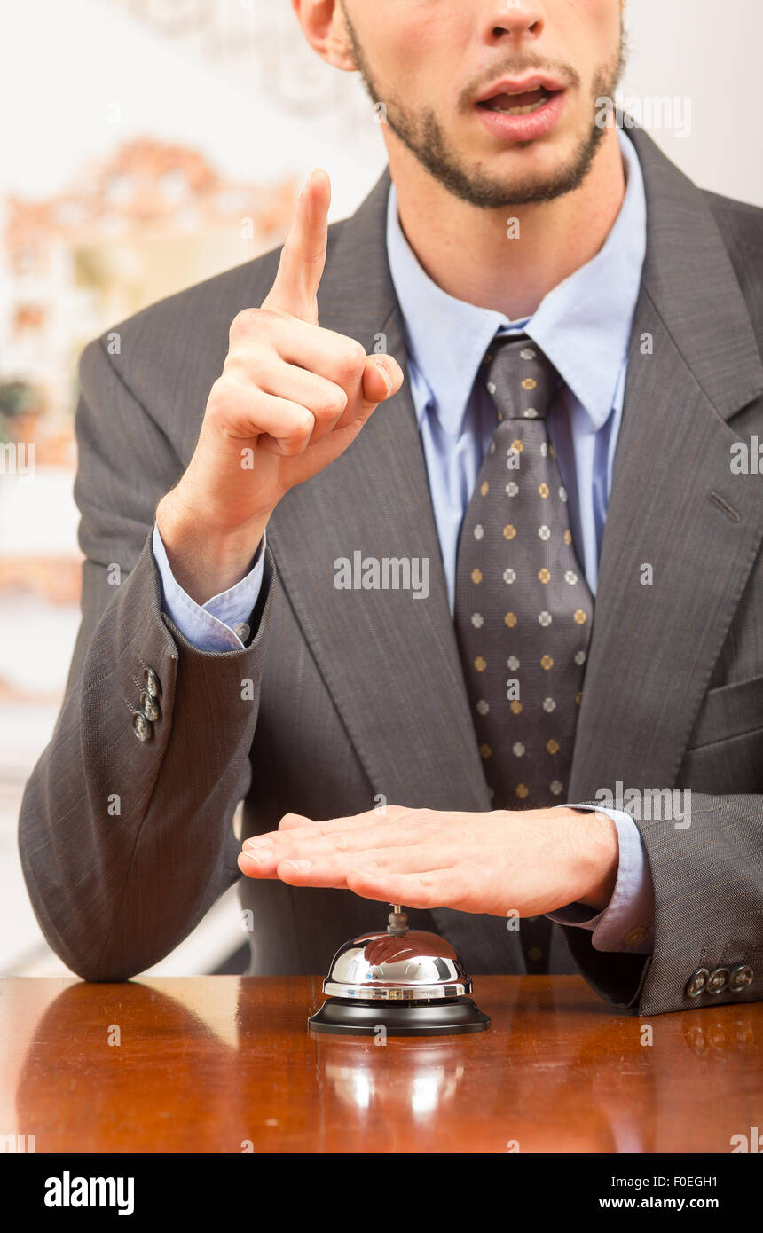 customer ringing hotel bell at reception desk Stock Photo - Alamy