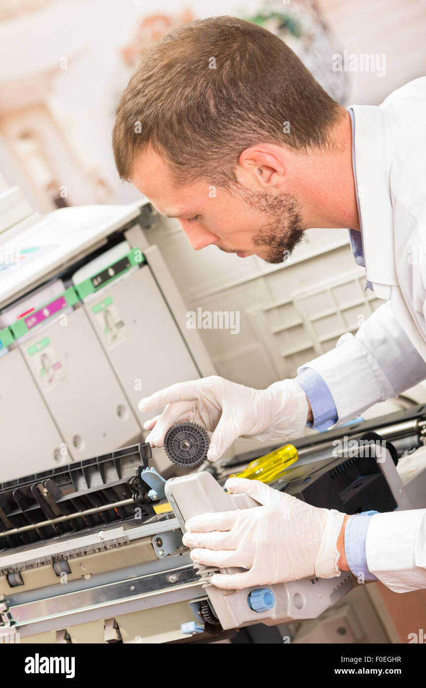 closeup shot technician fixing photocopier machine Stock Photo - Alamy